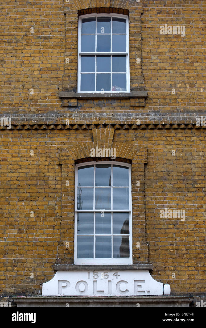 police 1864 plaque beneath two arched windows in a former police ...