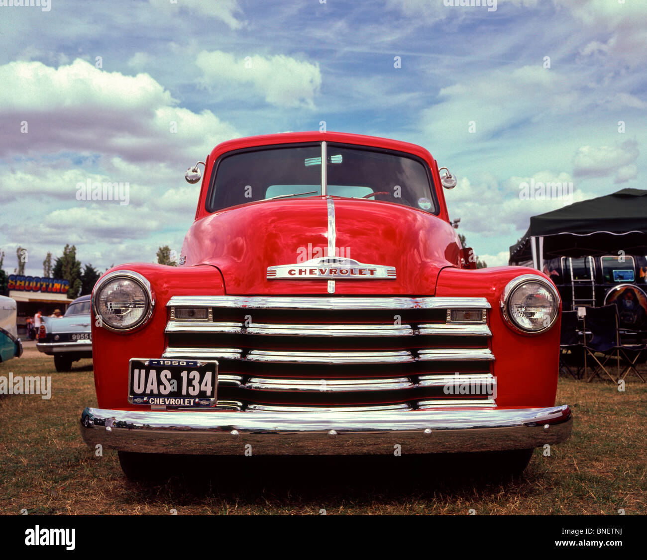 The front of a 1950s Chevrolet step side pick up red with chrome grill ...