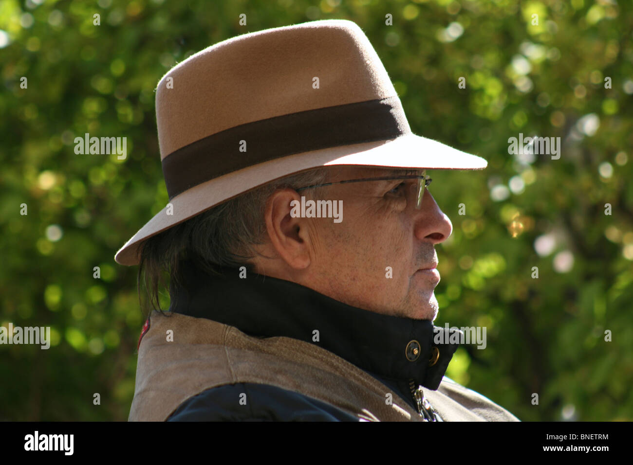 Side profile of a stall-holder wearing a beige fedora with dark brown ...
