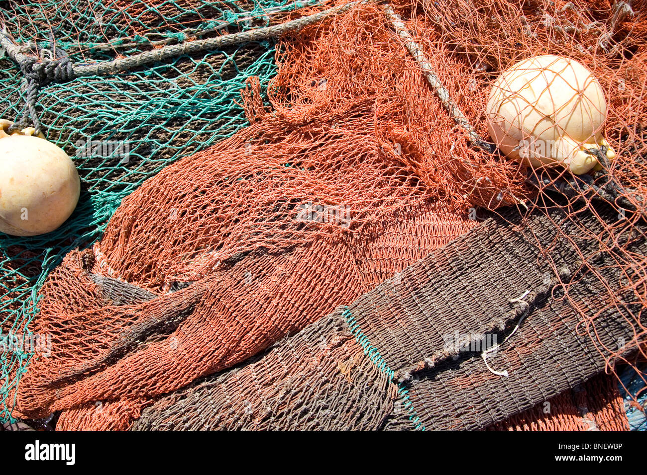 Orange fishing nets and floaters/ buoys Stock Photo - Alamy