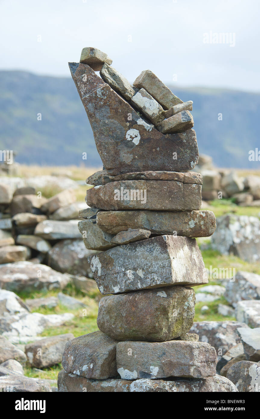Stones put together to create the shape of a person in a chair, close ...