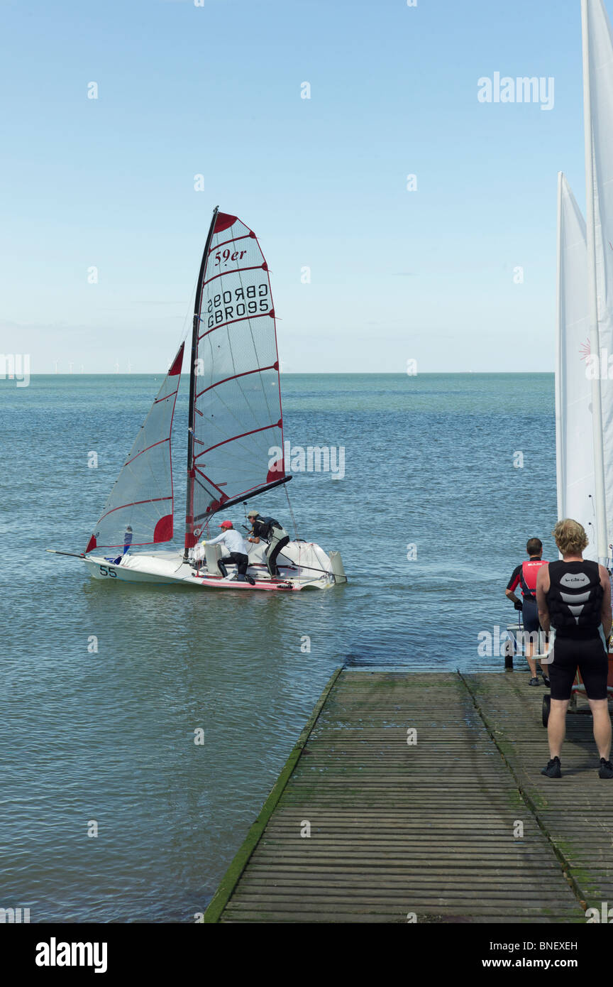 Launching sailing dingys from the jetty Stock Photo - Alamy