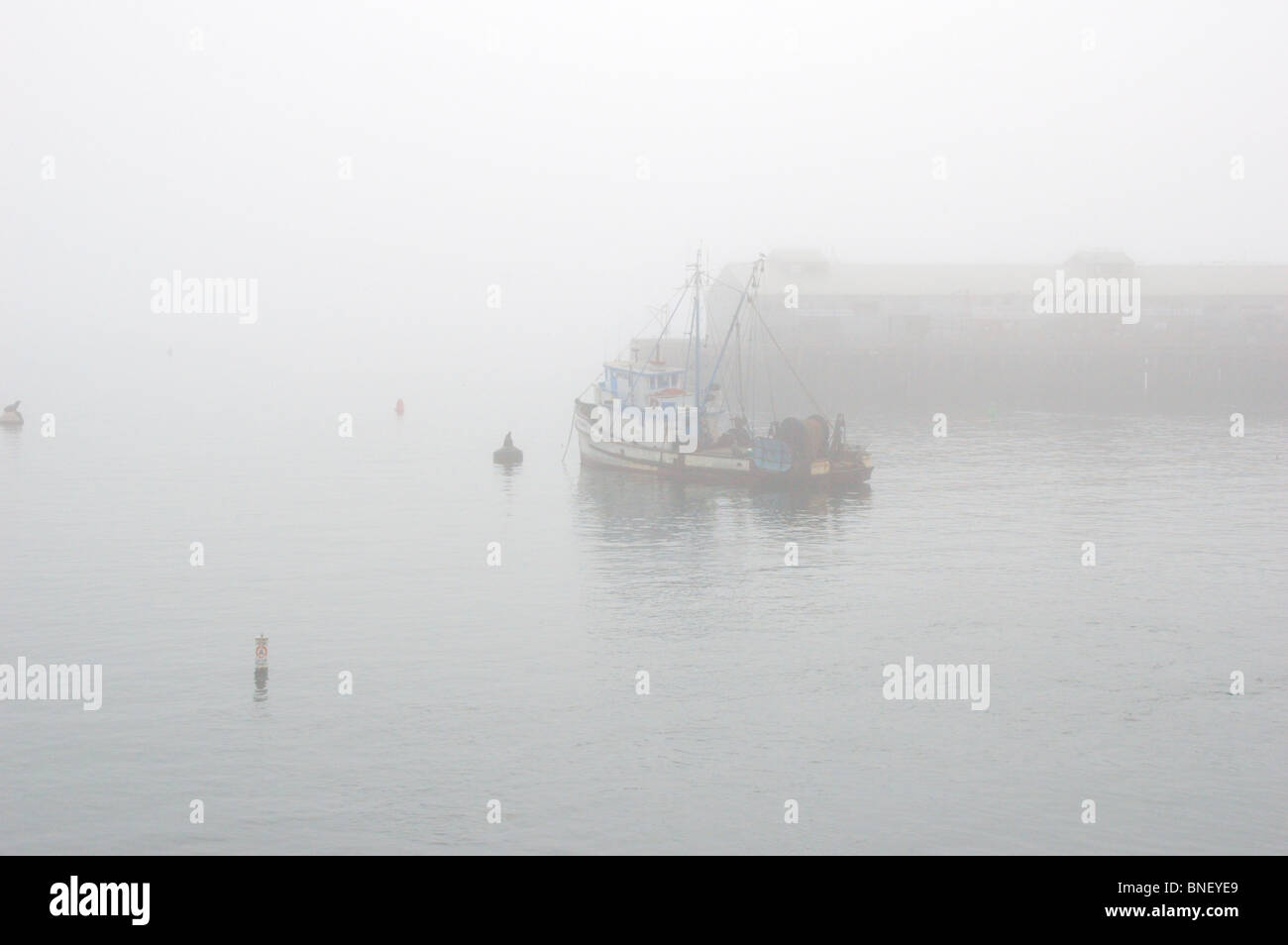 Fishing Boat in the morning mist Stock Photo - Alamy