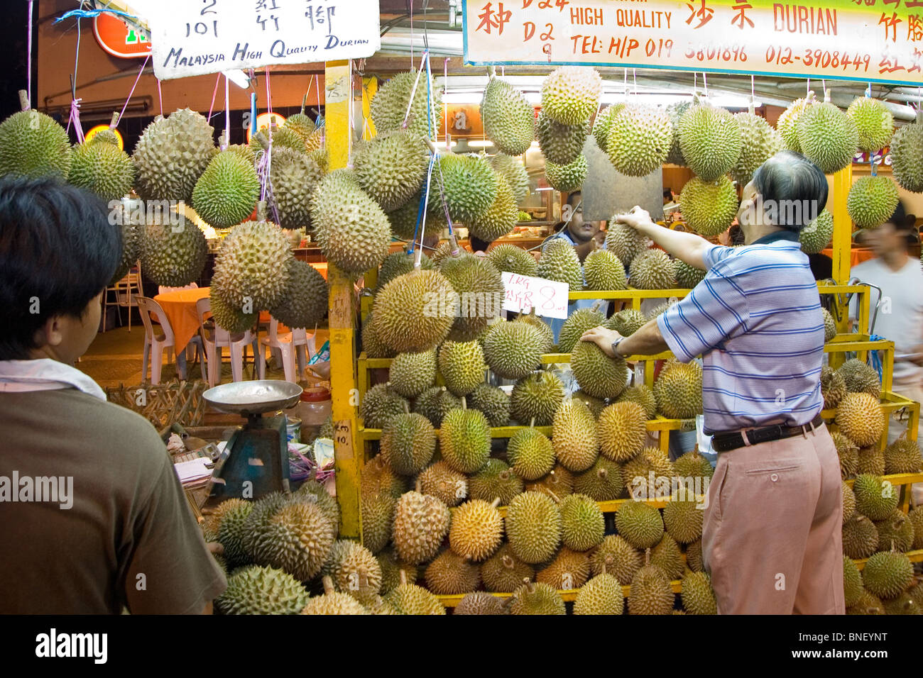 Man selling Durians at a fruit stall in Kuala Lumpur, Malaysia Stock ...