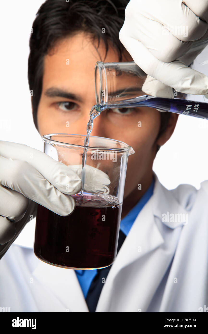 lab technician with beaker and flask, pouring Stock Photo - Alamy