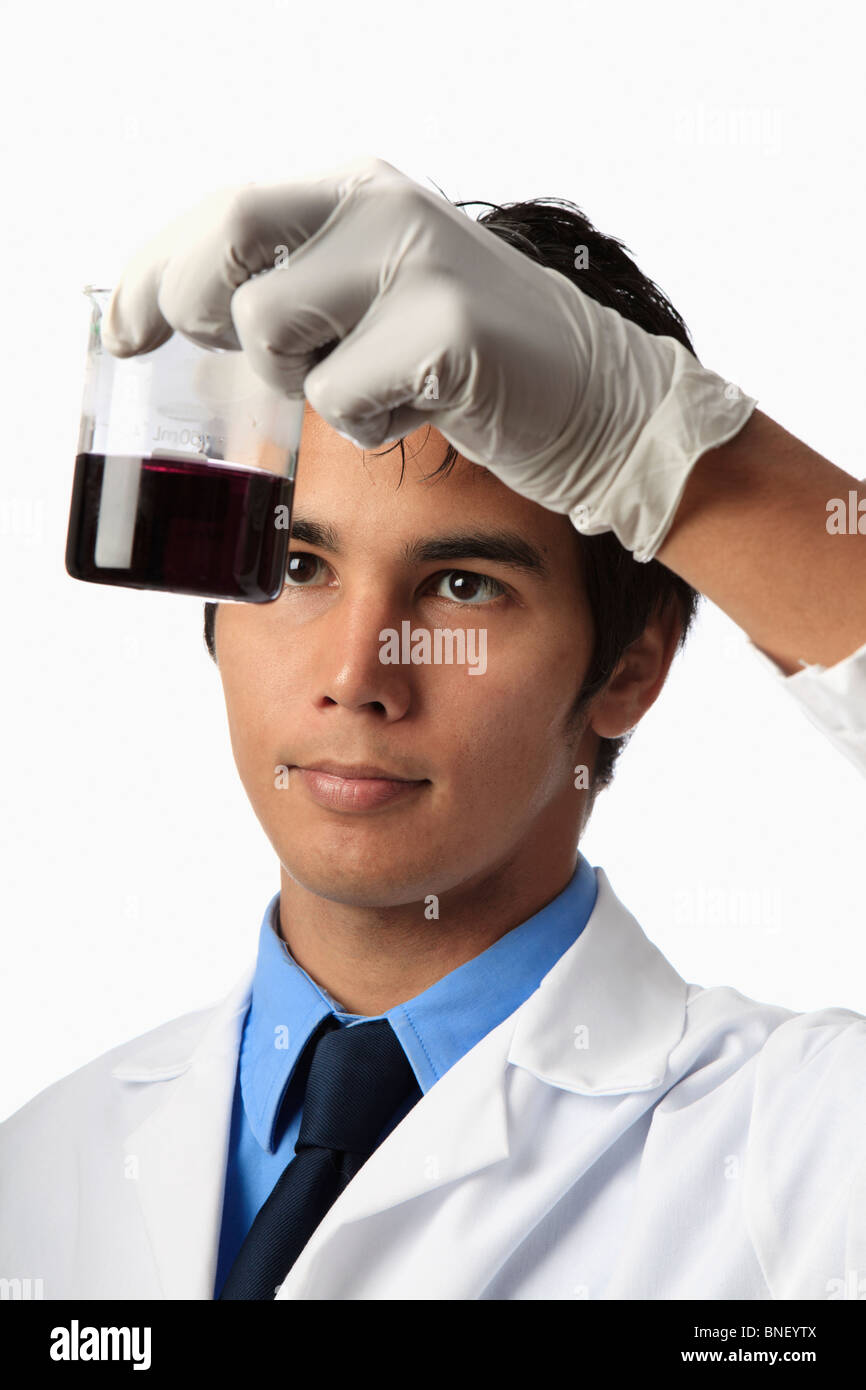 lab technician holding a flask with a fluid inside Stock Photo - Alamy
