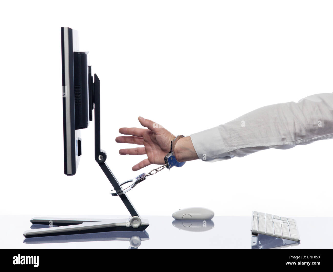 hand chained to computer with handcuffs addiction expression concept ...