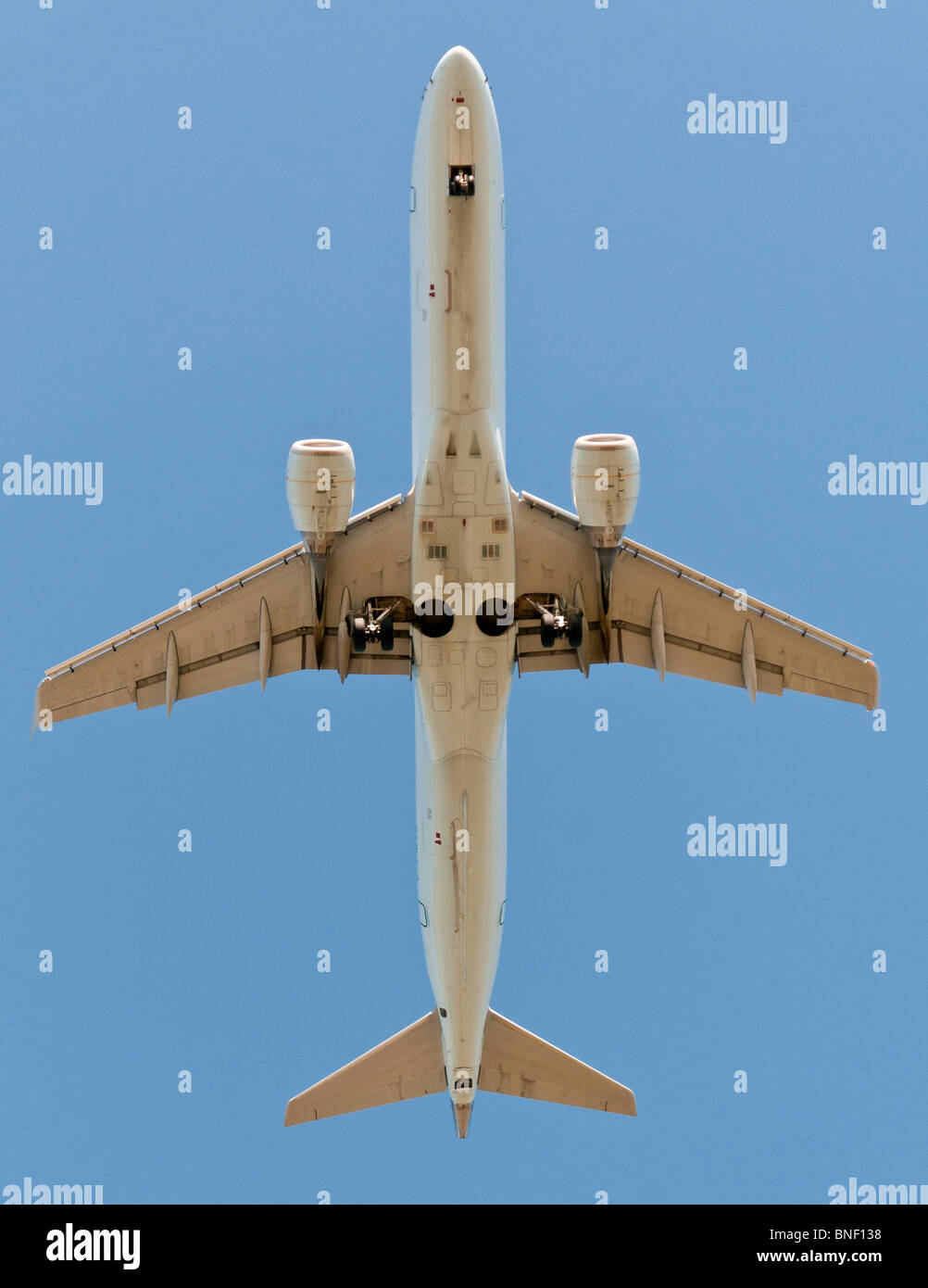 Looking straight up at a commercial jet airliner on final approach for ...