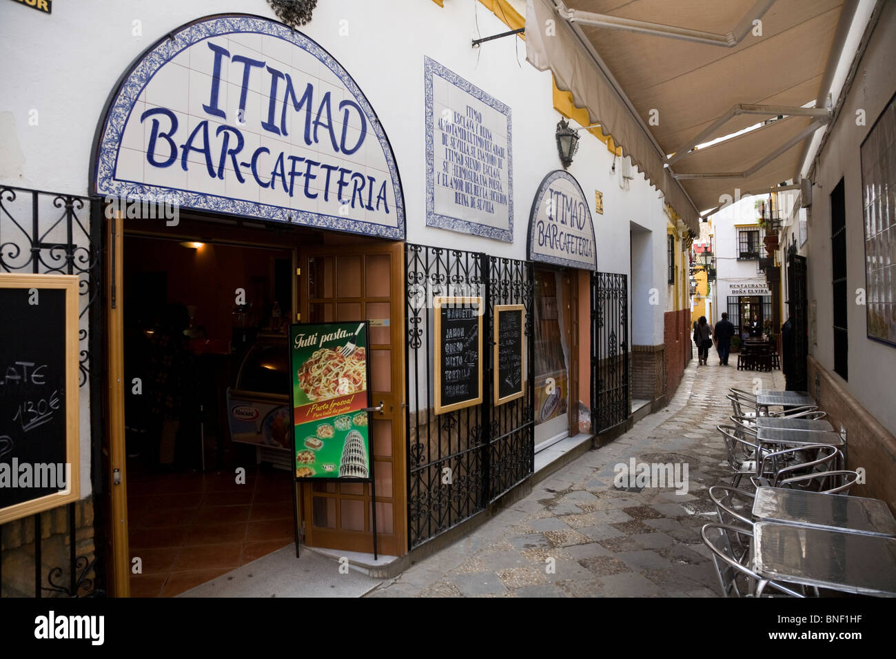Typical Seville street with Itimad bar / cafe / cafeteria / restaurant ...