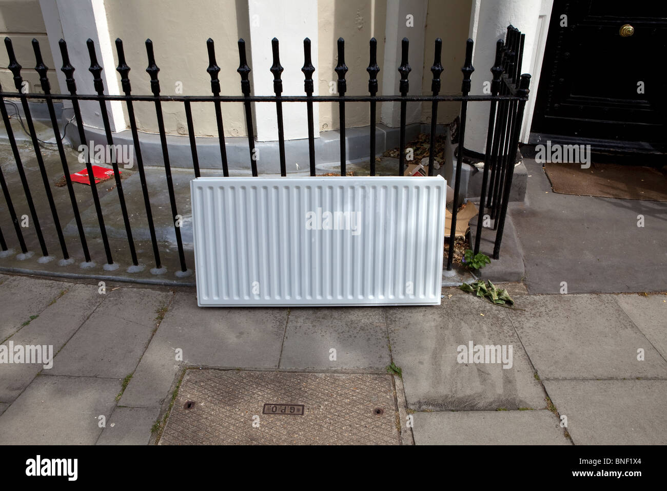 Old radiator dumped on Pavement Stock Photo - Alamy