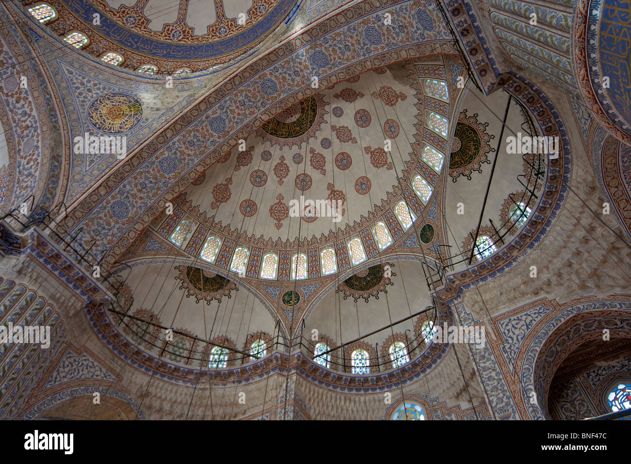 High ceiling and interior of the Blue Mosque with domes covered in blue ...