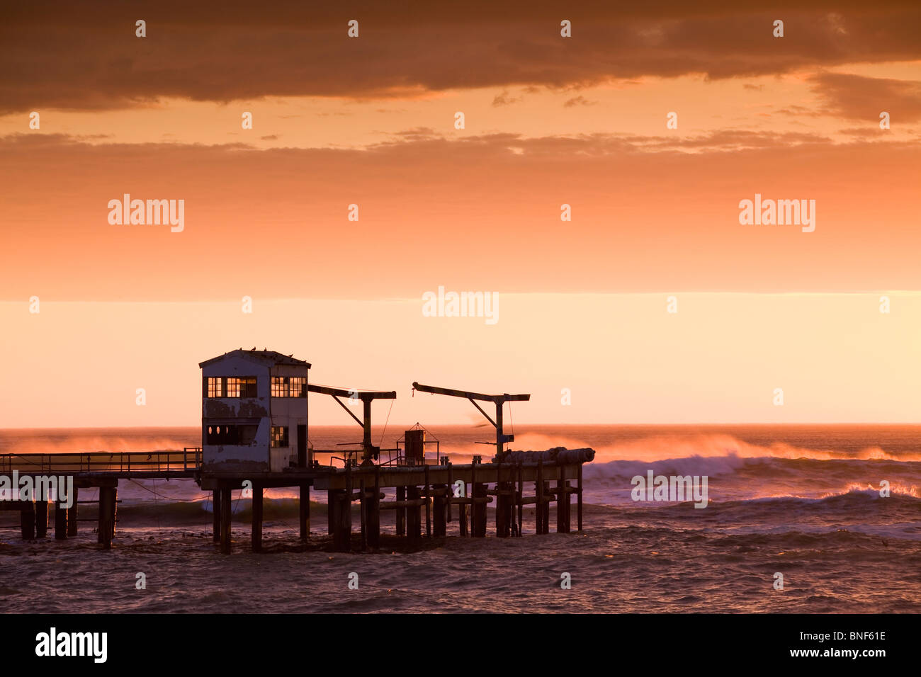 Old harbor pier being battered by stormy sea, Doring Bay, Western Cape ...