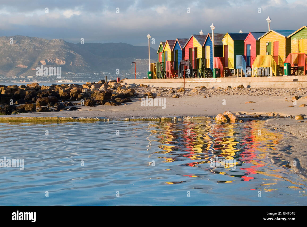 Colorful beach huts reflecting in water, St. James, Kalk Bay, Western ...