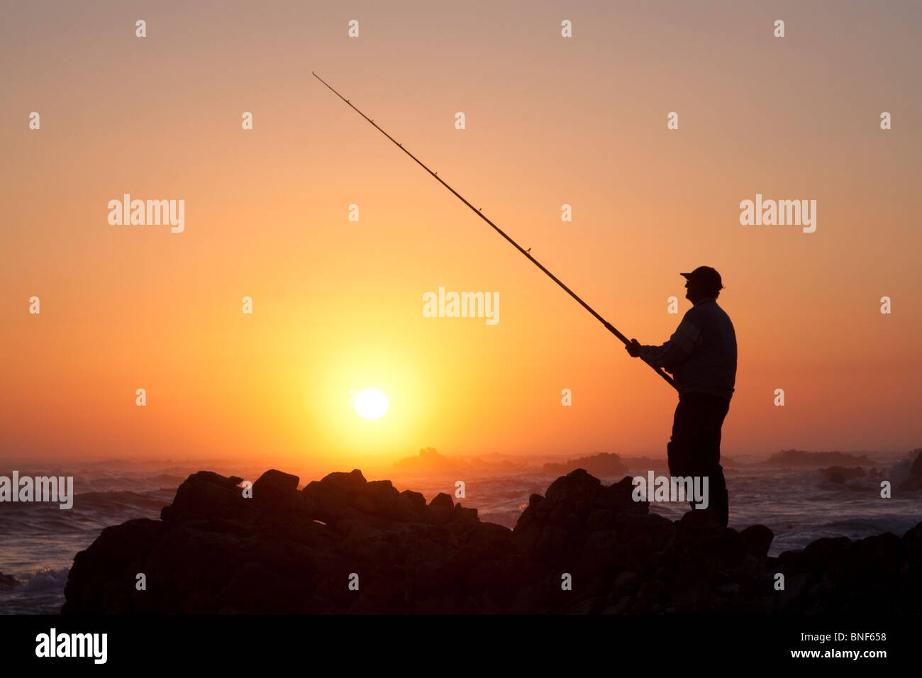 Fisherman at sunset Stock Photo - Alamy