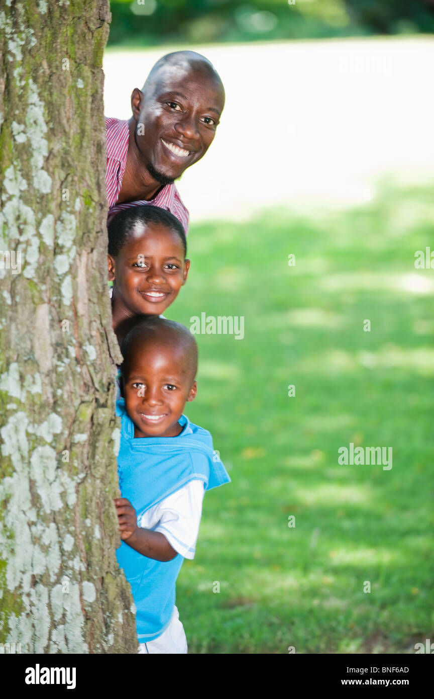 Two boys hiding behind tree hi-res stock photography and images - Alamy