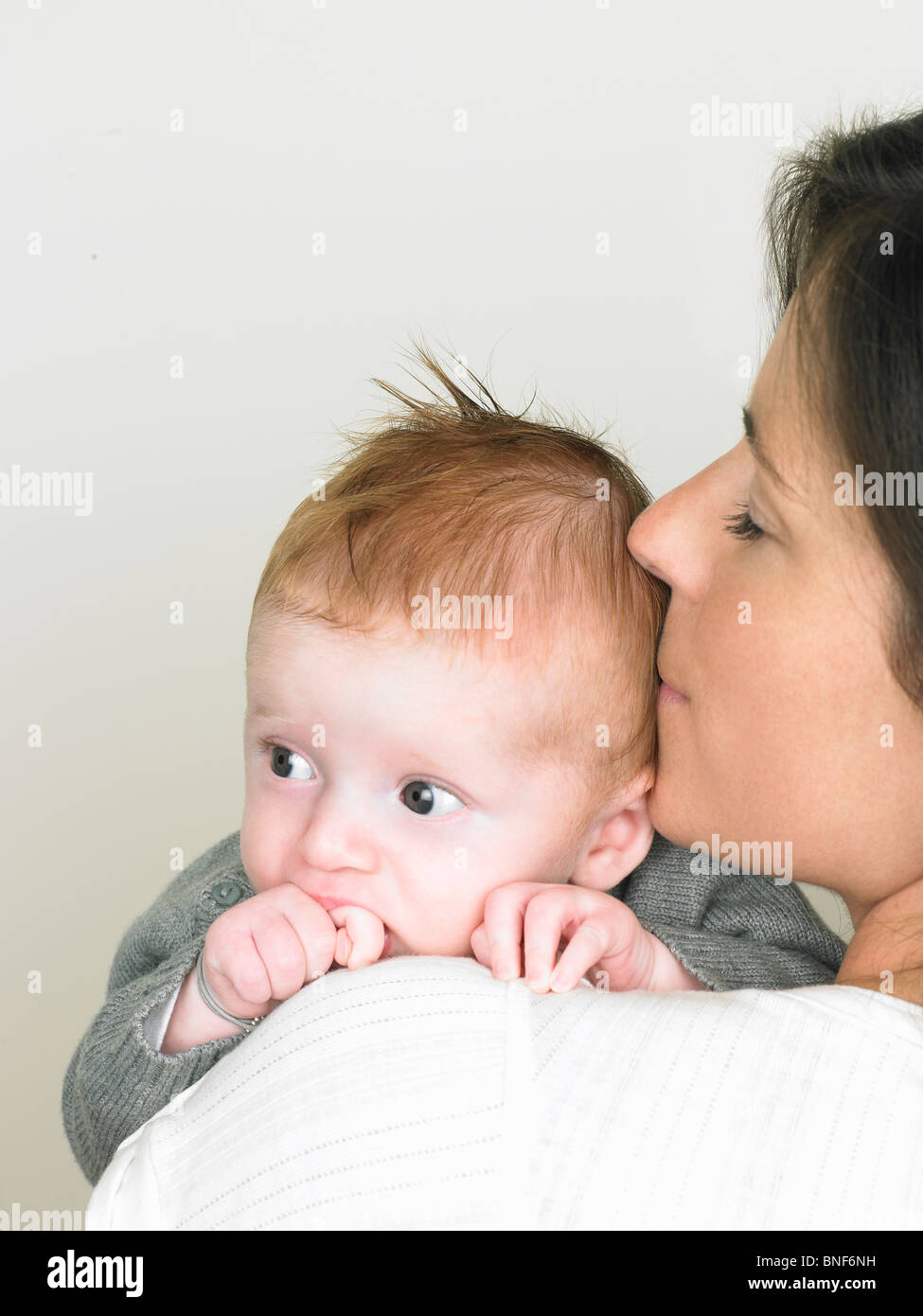 Baby on mothers shoulder Stock Photo - Alamy