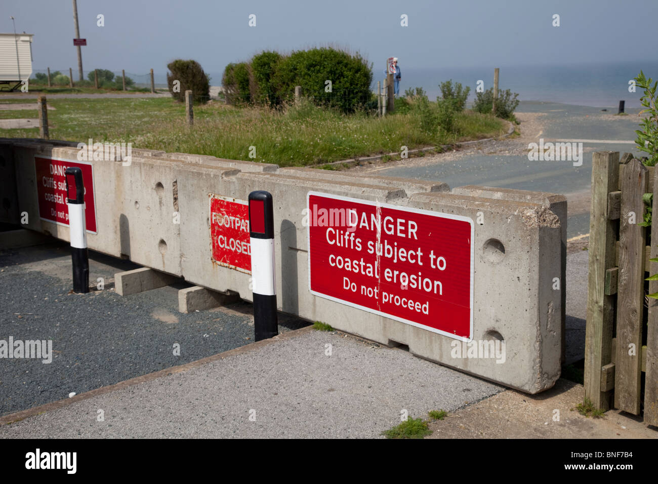 Danger collapsing cliffs signs on blocked coast road Skipsea East ...