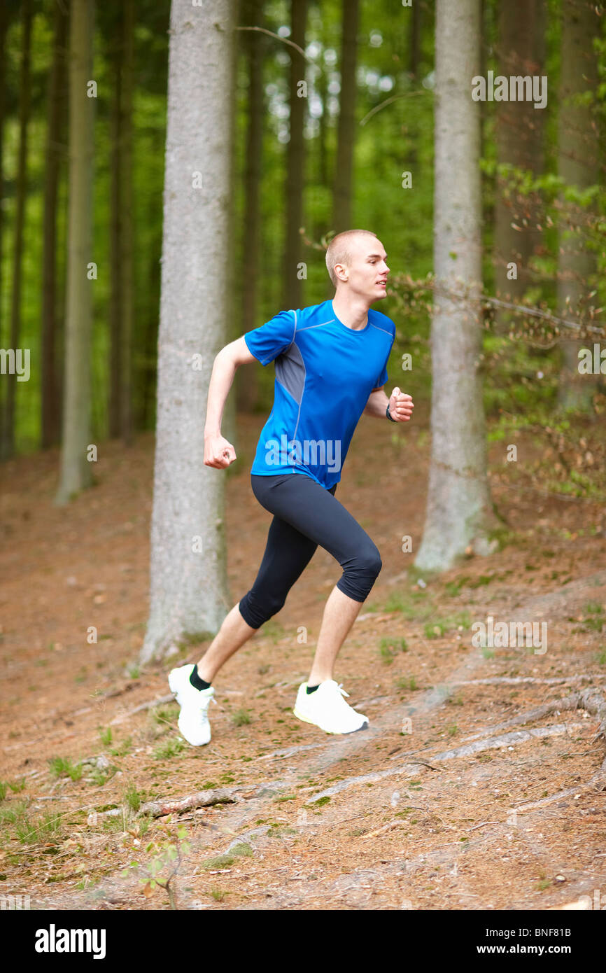 Man running in forest Stock Photo - Alamy