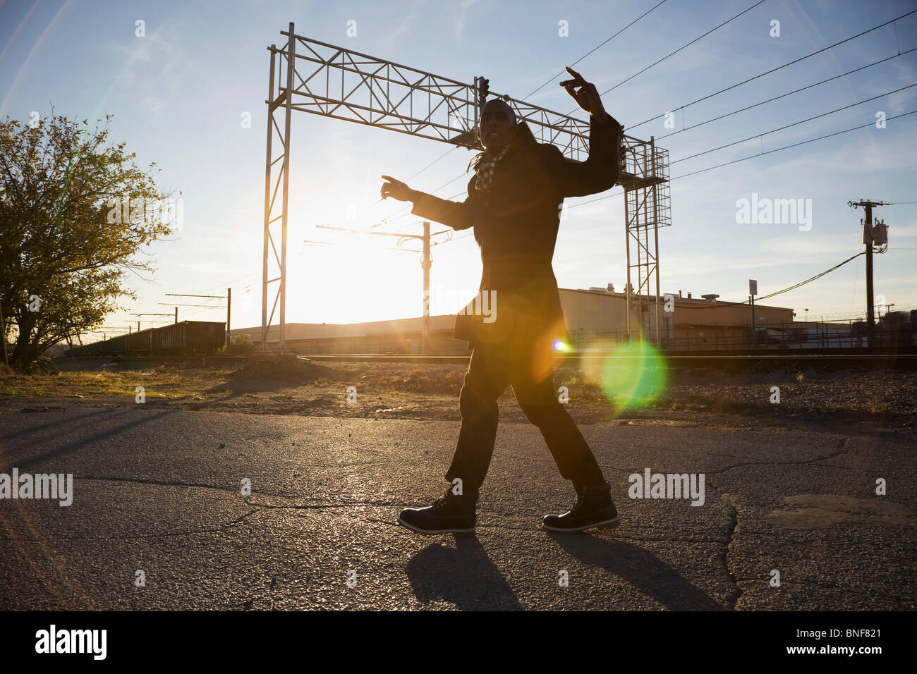 Young man walking on the road Stock Photo - Alamy