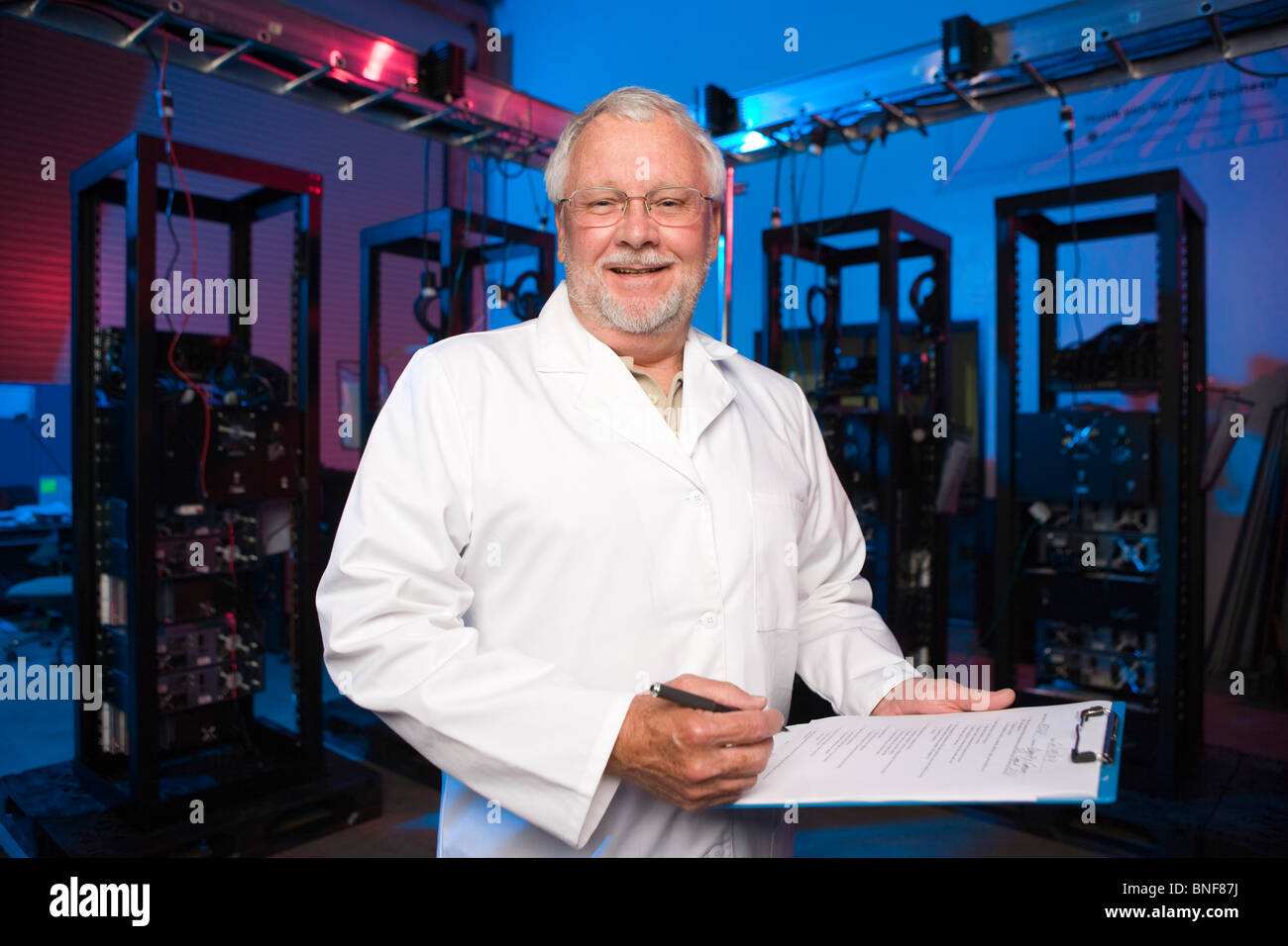 Computer programmer holding a clipboard in a computer lab Stock Photo ...