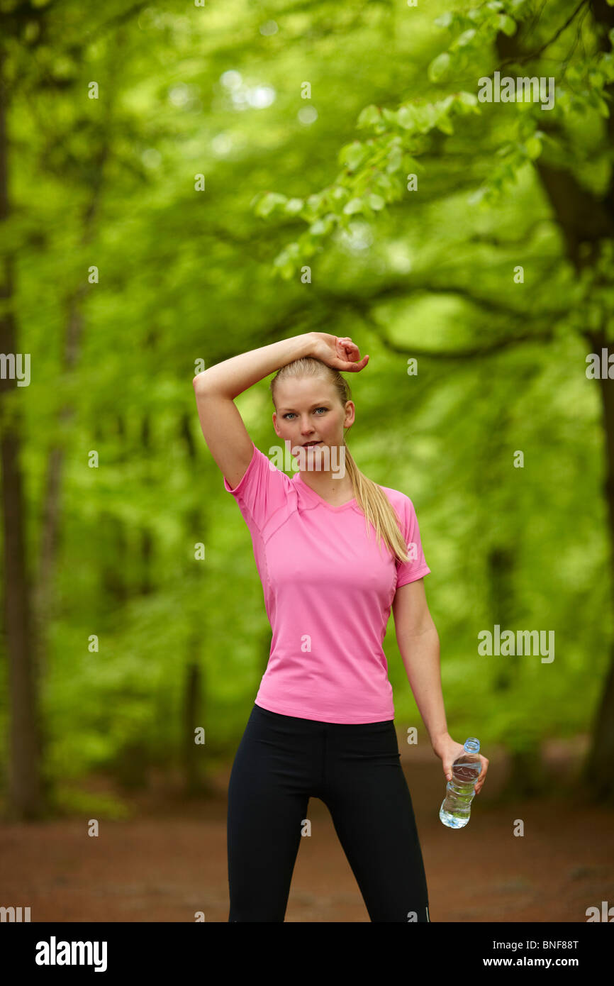 Woman running, standing still with water Stock Photo - Alamy