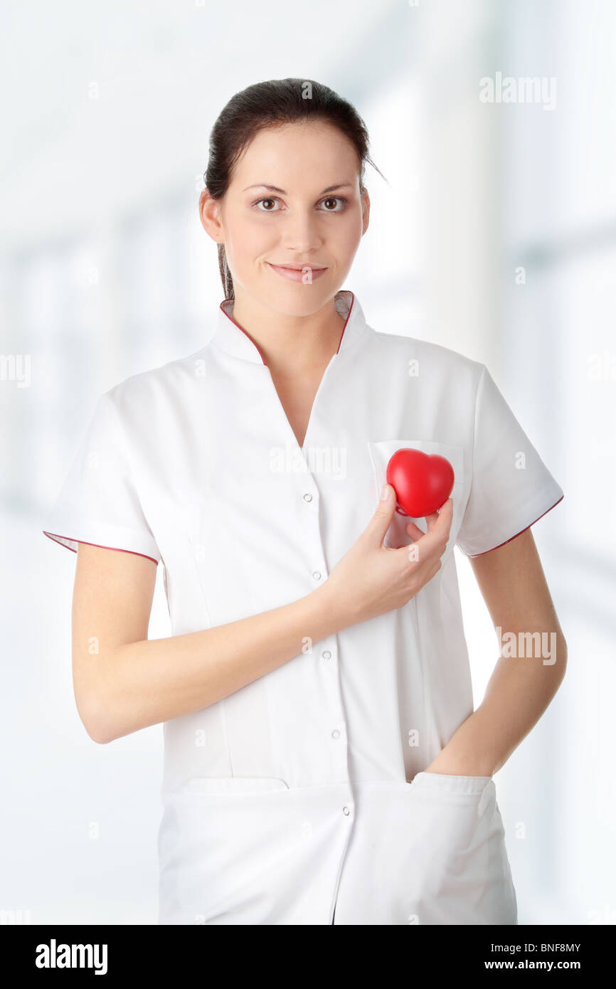 Young nurse with heart in her hand Stock Photo - Alamy