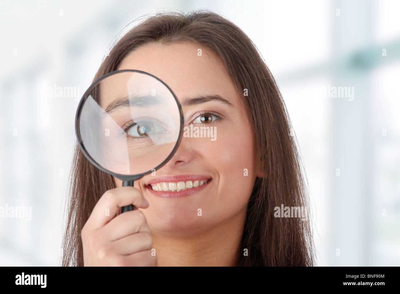 The woman with a magnifier in a hand Stock Photo - Alamy