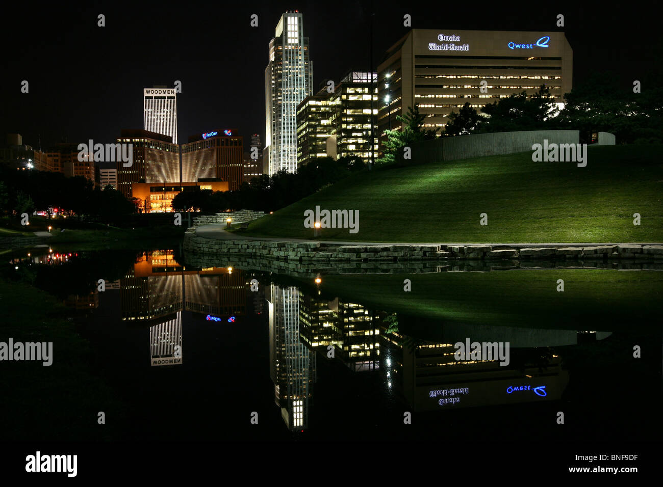 USA, Nebraska, Omaha, Park at night with skyscrapers in background ...