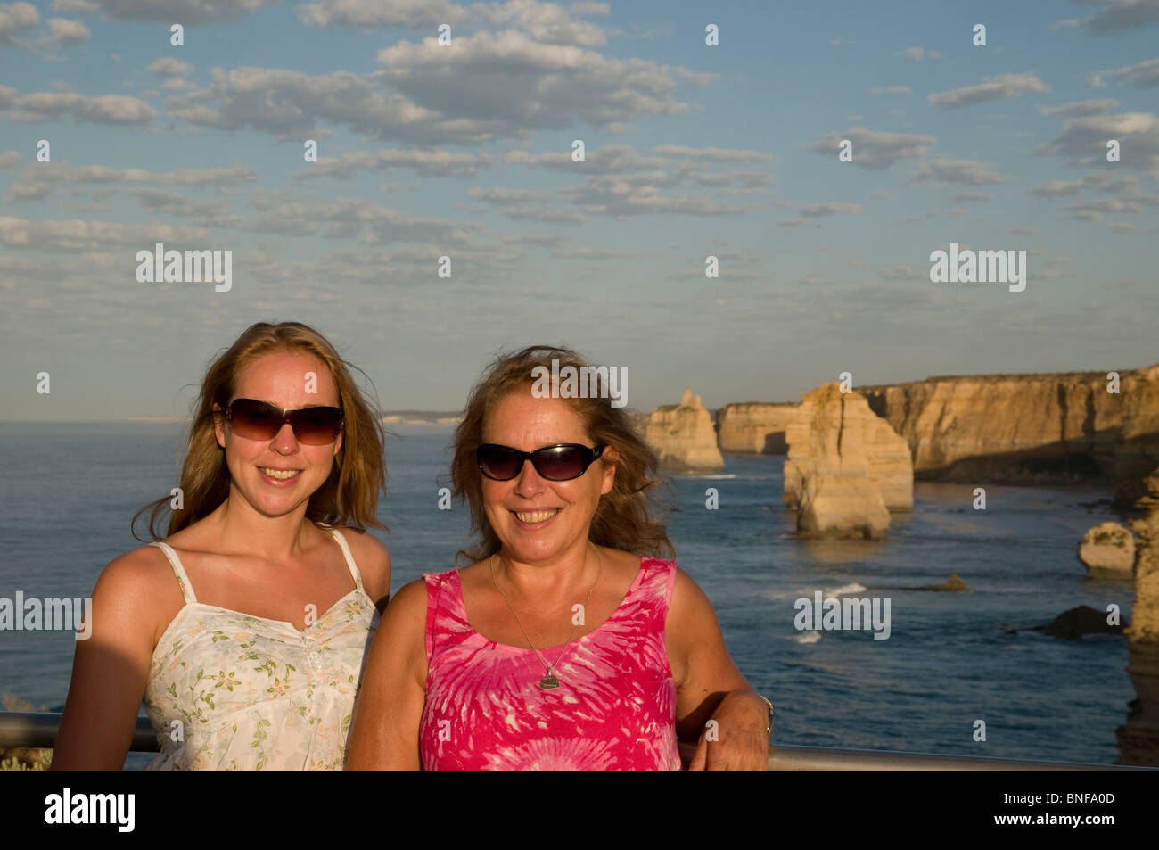 Portrait of two women standing with The Twelve Apostles in the ...