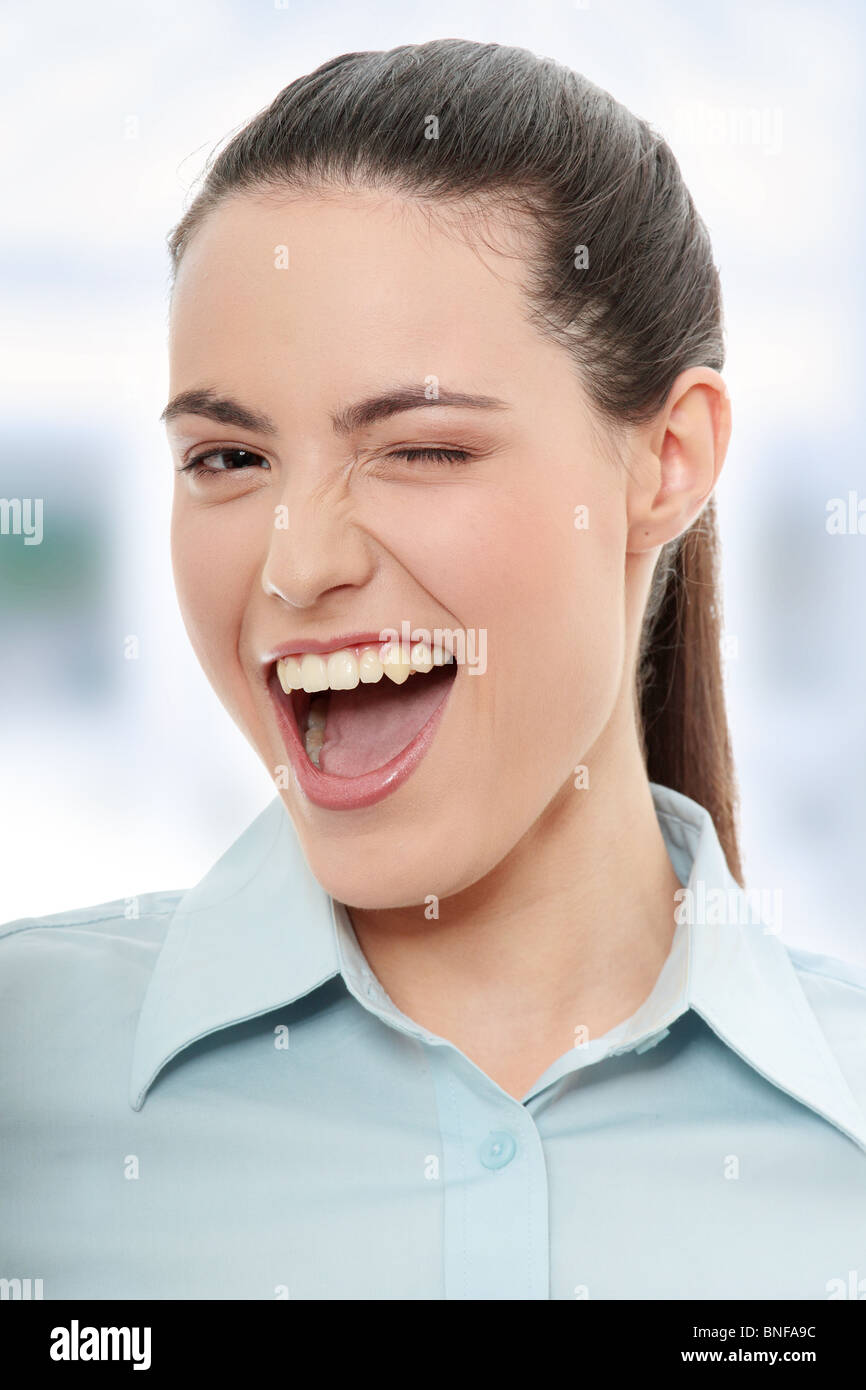 Businesswoman with big smile blinking Stock Photo - Alamy