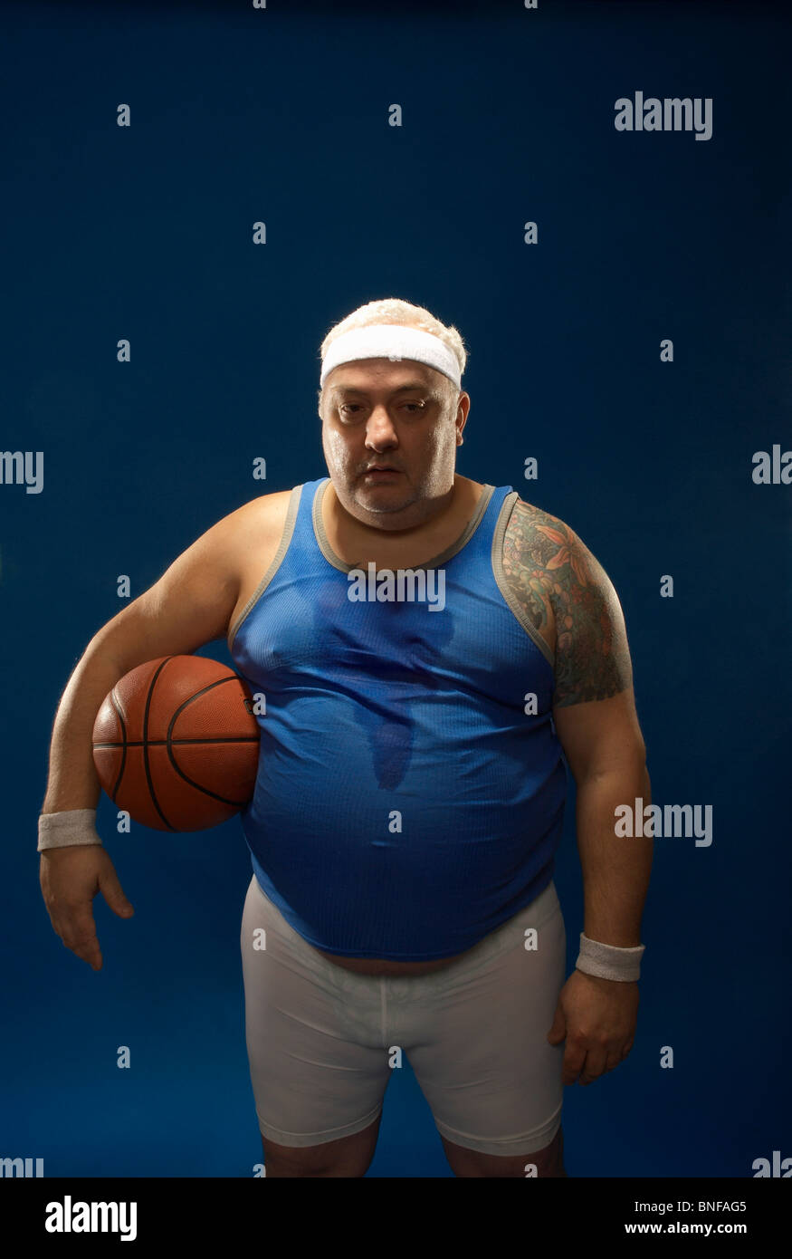 Large sportsman holding basketball Stock Photo - Alamy