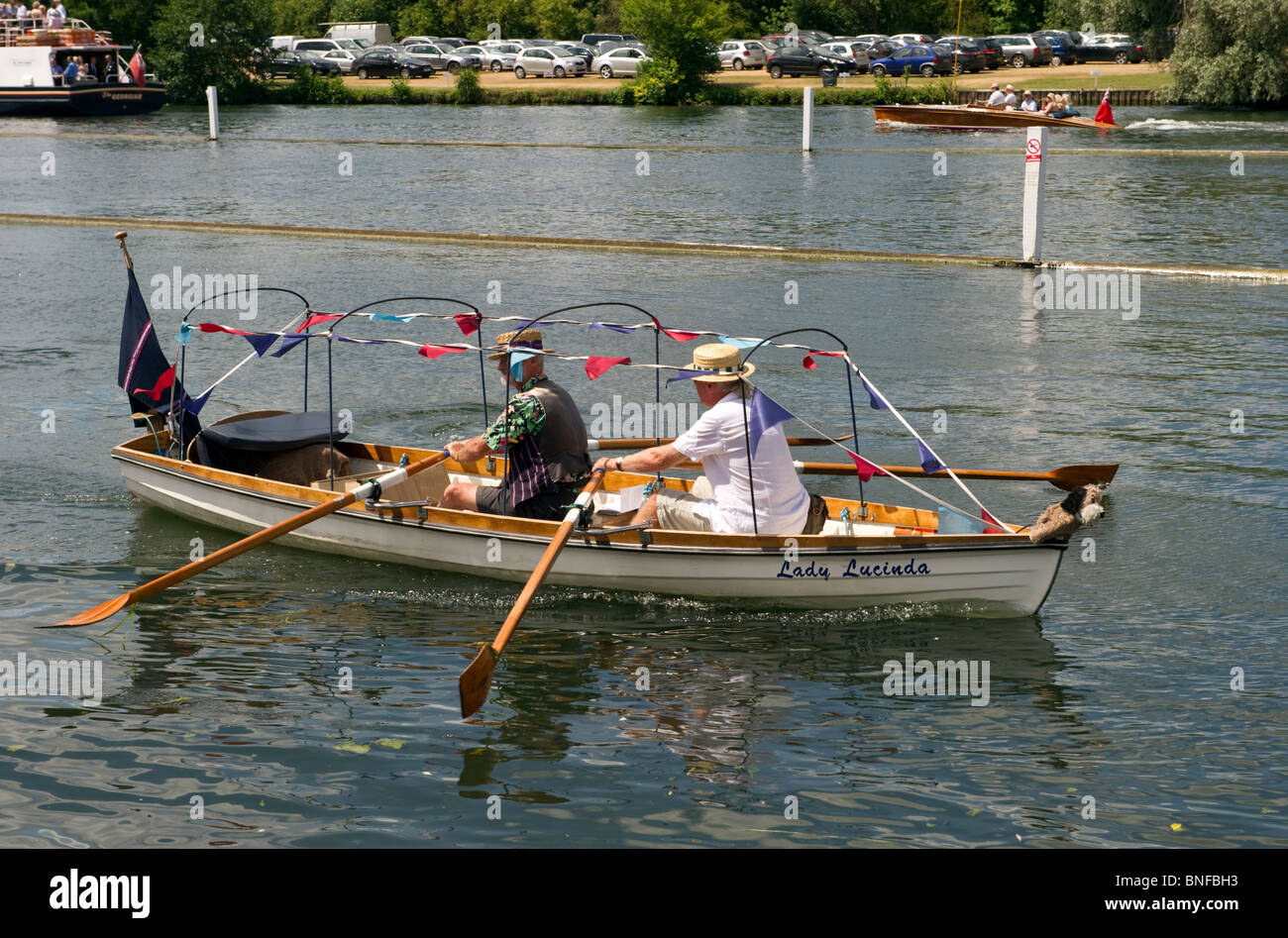 Two traditionally dressed men rowing a boat on the River Thames during ...