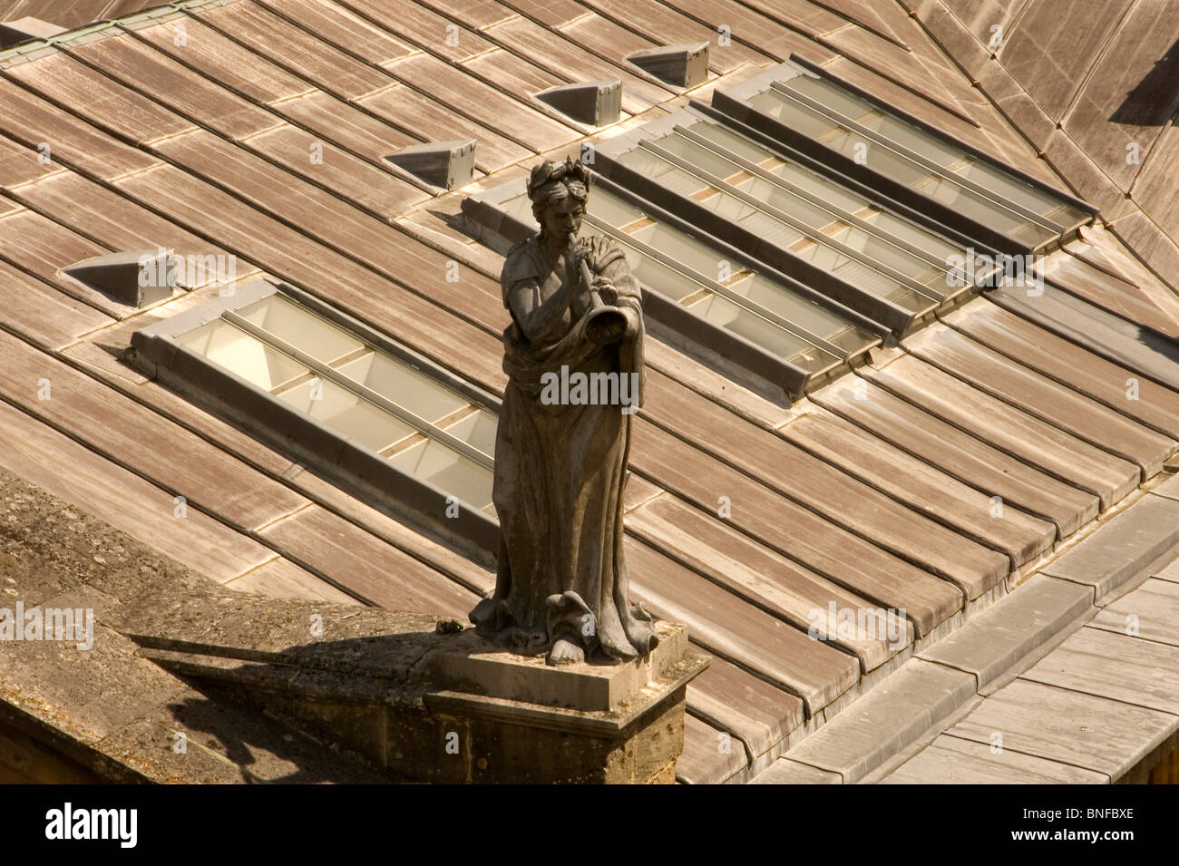 statue picturing a muse on the top of the roof of the Bodleian Library ...