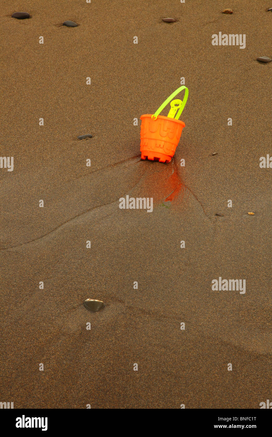 Bucket and spade on a beach Stock Photo - Alamy