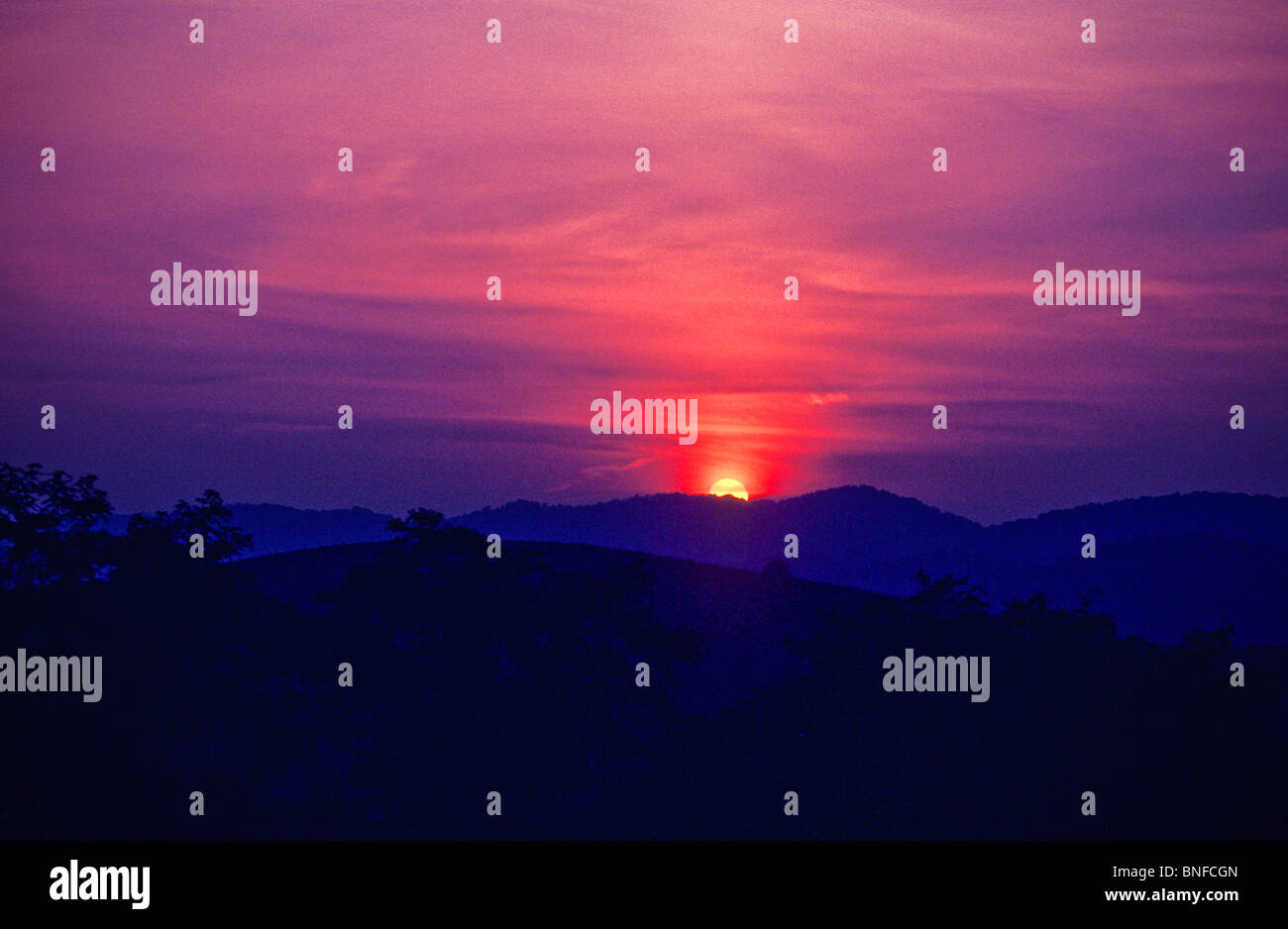 cloudy skies bright red sunset over NH mountains copy space Stock Photo ...