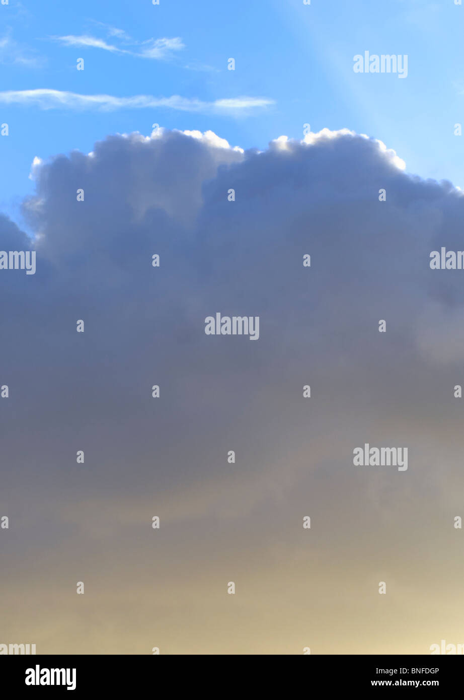 Close up of rain clouds at sunset with sunlight hitting the upper edges ...