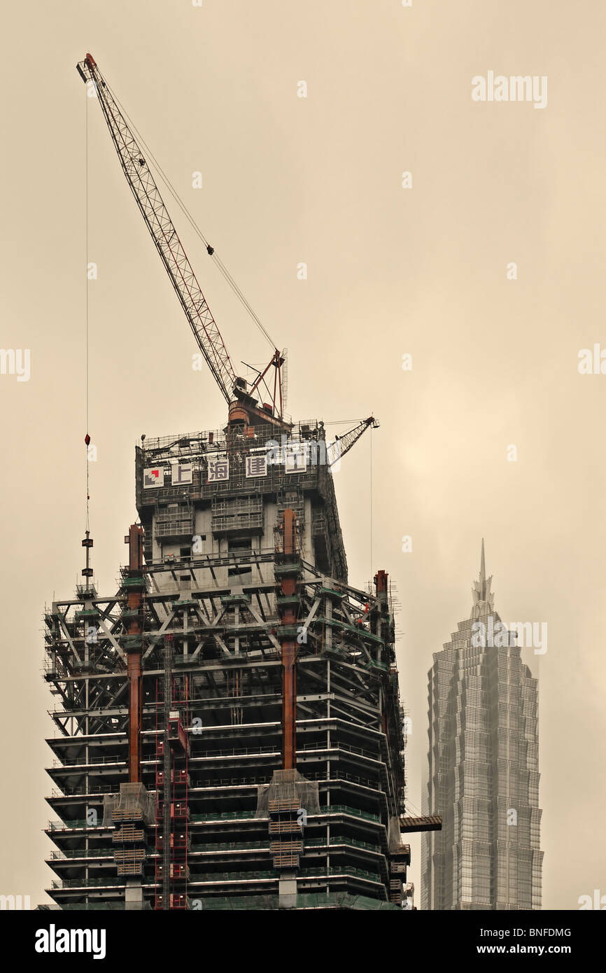 New skyscraper construction in Shanghai, China - in red and sepia color ...