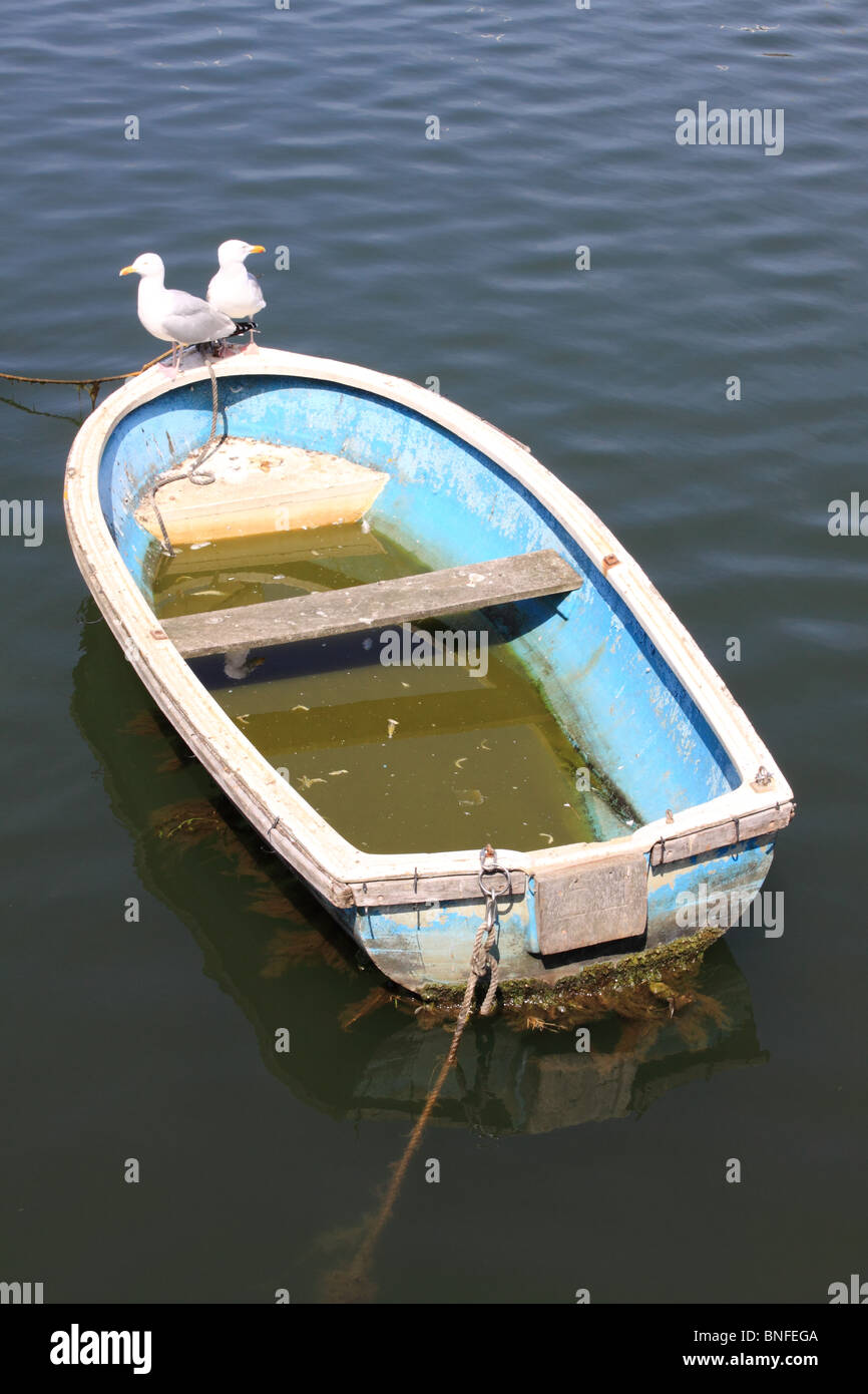 small leaky rowing boat in Whitehaven marina Stock Photo - Alamy