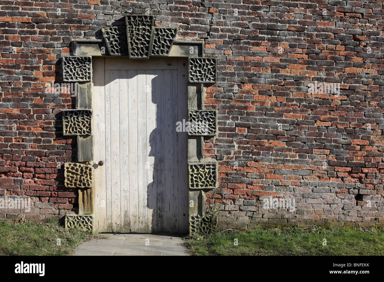 Wooden door in a Rustic brick wall at Harewood Estate, near Leeds, West ...
