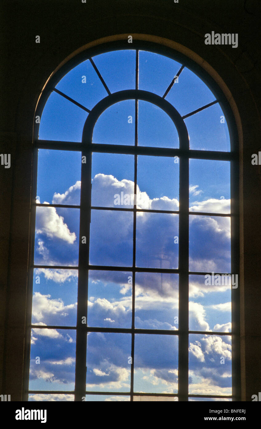 cloudy skies arched window frame Stock Photo - Alamy