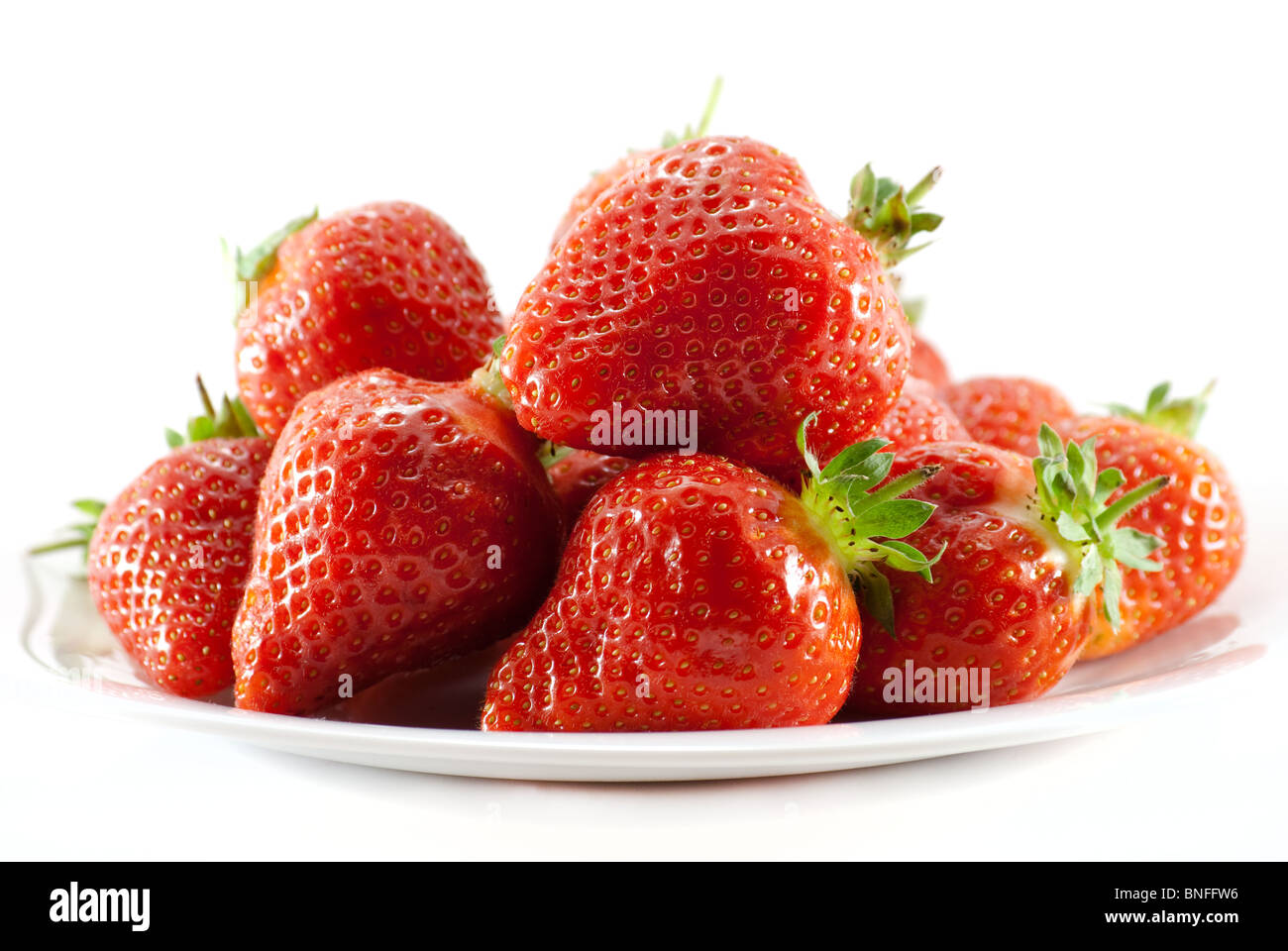Plate red strawberries isolated Cut Out Stock Images & Pictures - Alamy