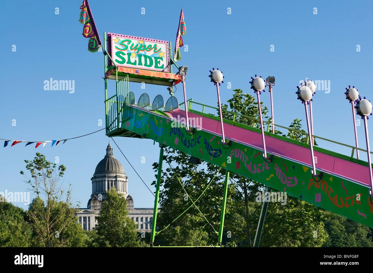 A super slide carnival ride is set up for the Capital Lakefair ...