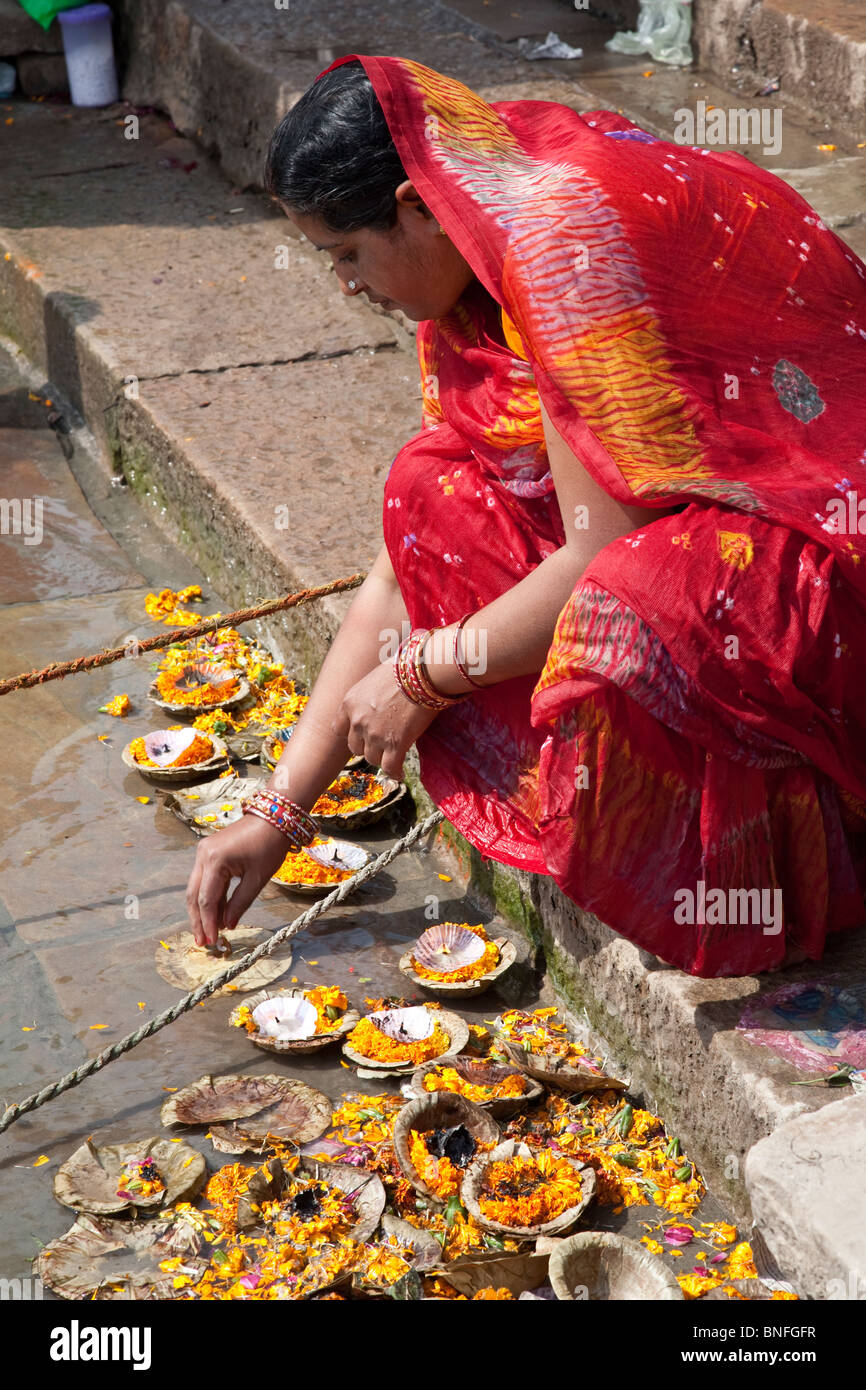 Woman making a ritual offering. Ganges river. Varanasi. India Stock ...