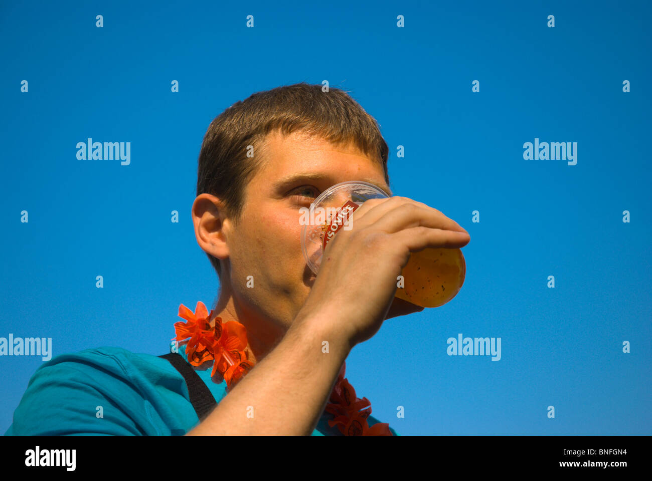 Russian man in his thirties drinking beer out of a plastic cup Prague ...