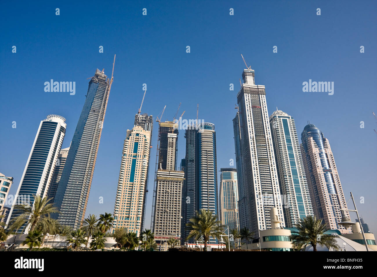 Skyline of Dubai, UAE, with construction cranes atop buildings Stock ...