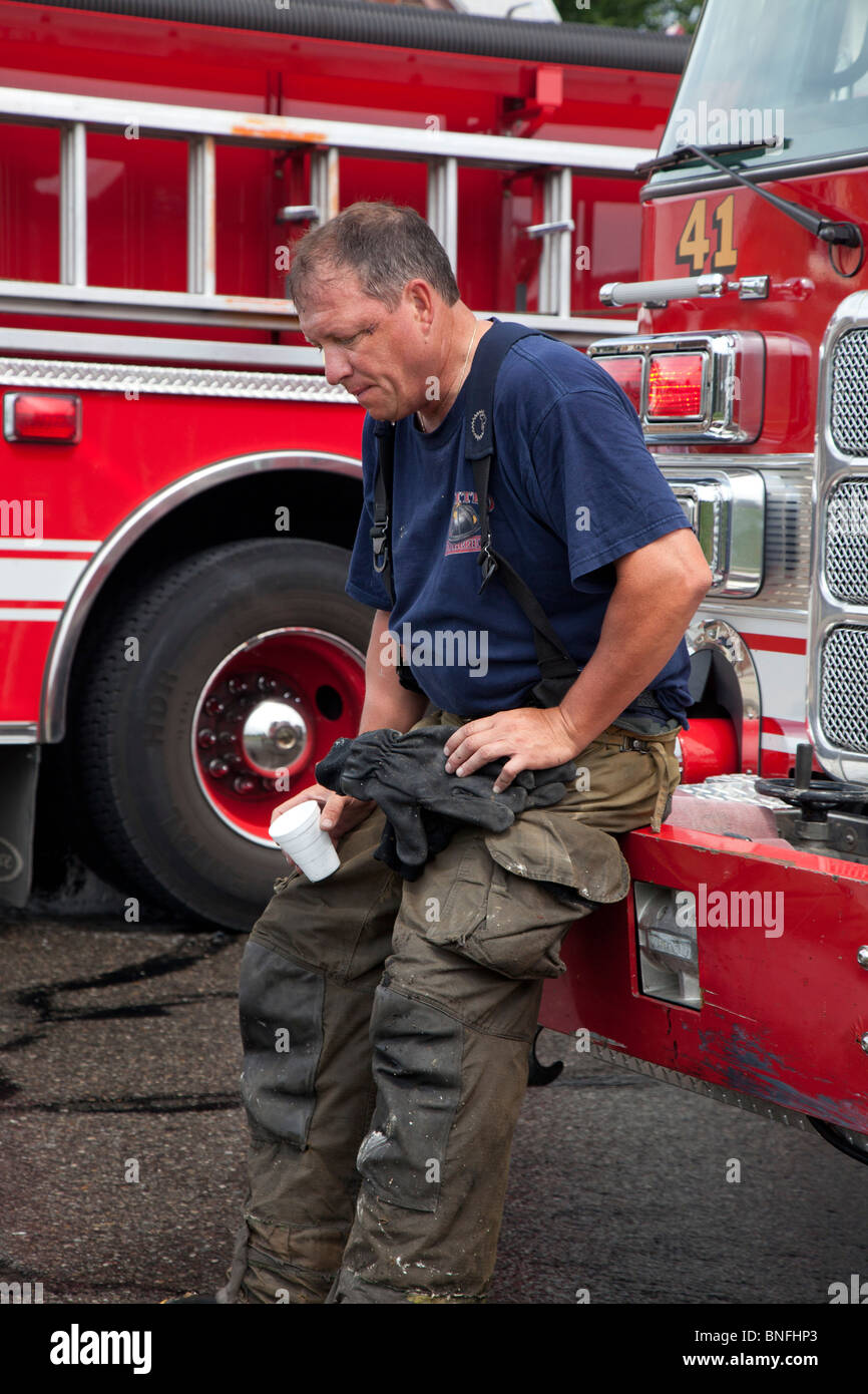 Detroit, Michigan - An exhausted fire fighter takes a break while ...