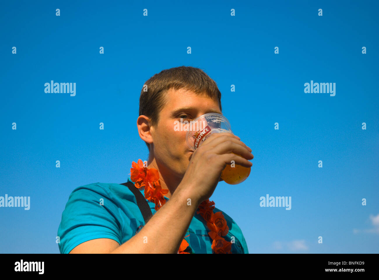 Russian man in his thirties drinking beer out of a plastic cup Prague ...