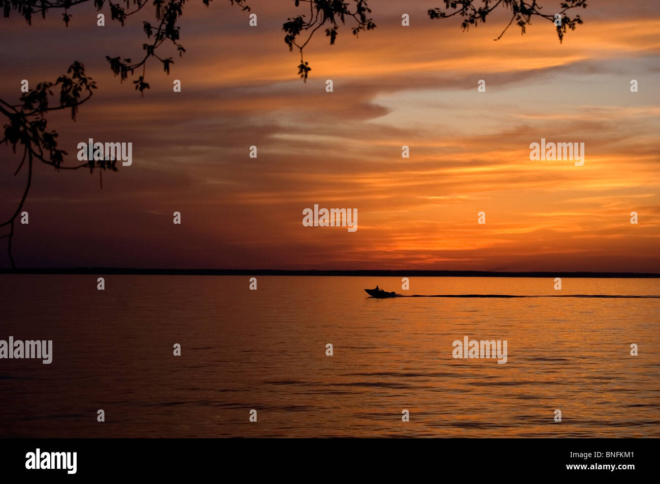 Boating on the lake at sunset Stock Photo - Alamy