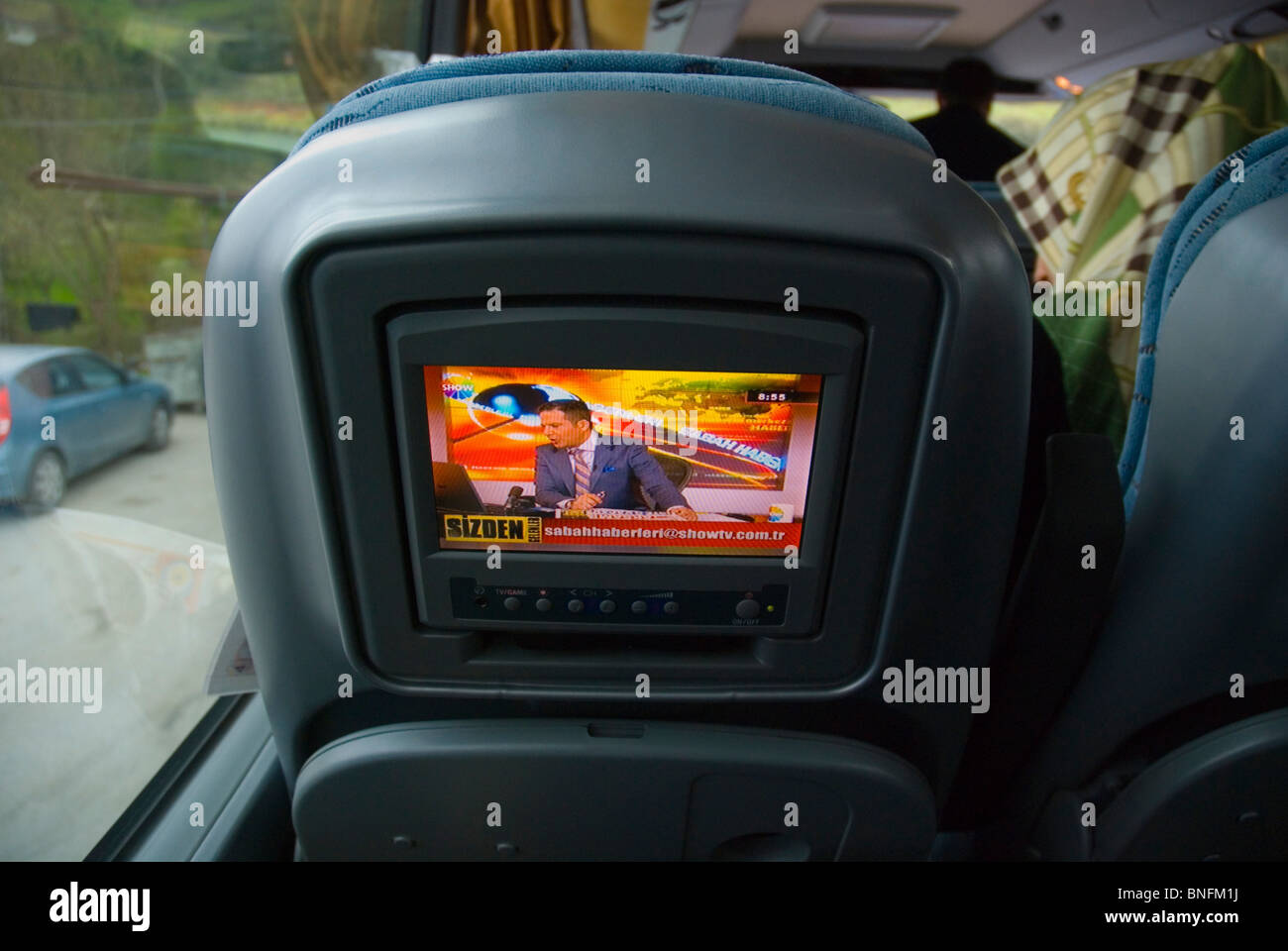 Tv screen attached to bench on bus in Turkey Stock Photo - Alamy