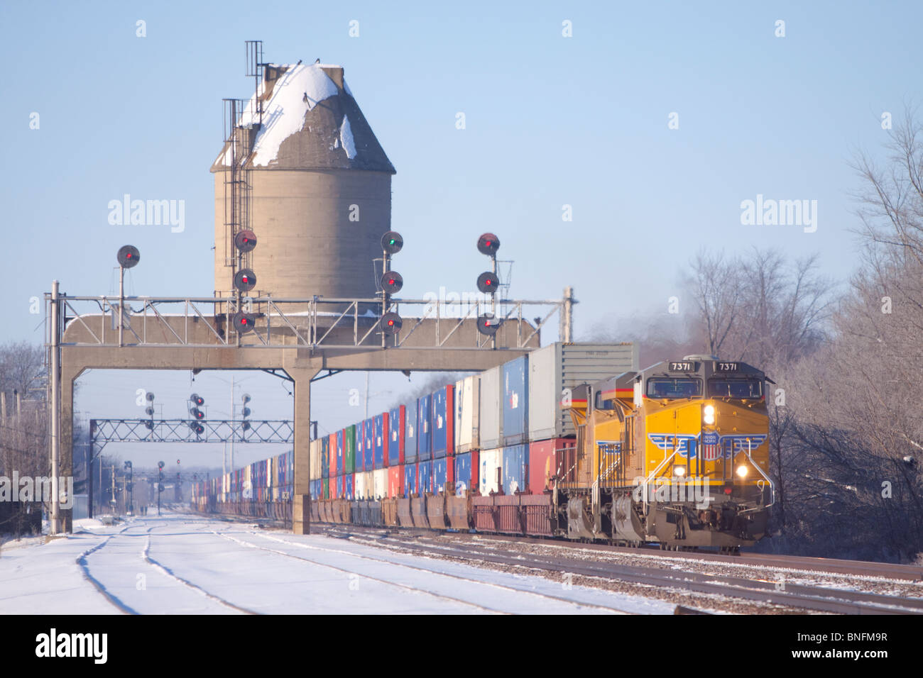 A Union Pacific intermodal freight train rolls across a snowy winter landscape in Northern ...